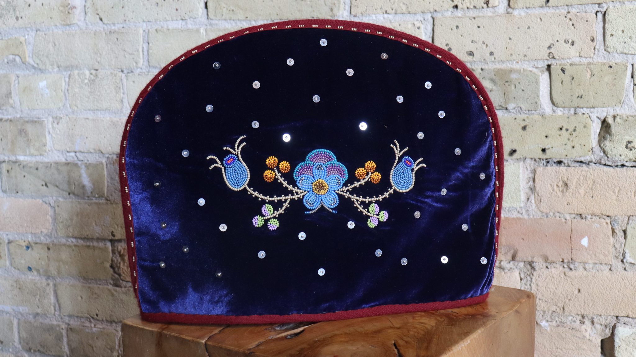 A tea cozy created by Melanie Gamache features a traditional five-petal ...